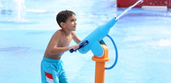 Boy plays the water gun at HEB Splash Park - Texas State Aquarium